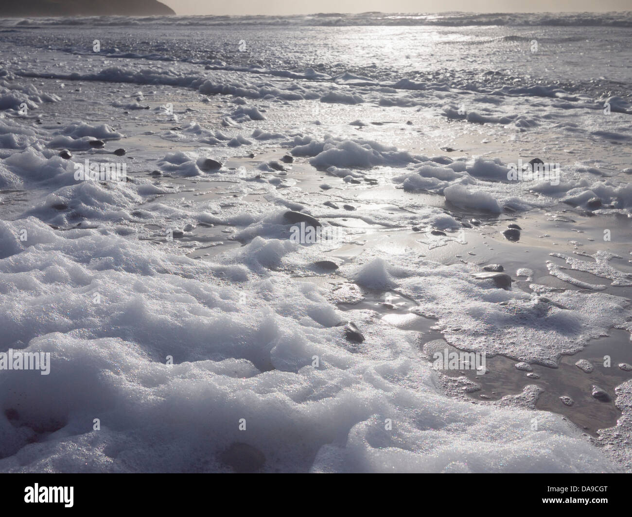 Spume on the beach Stock Photo - Alamy