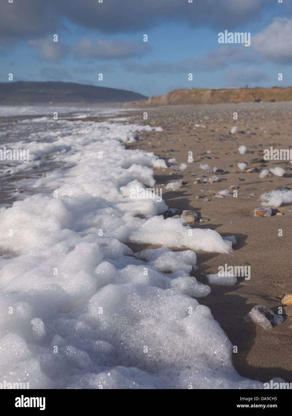 Spume on the beach Stock Photo - Alamy