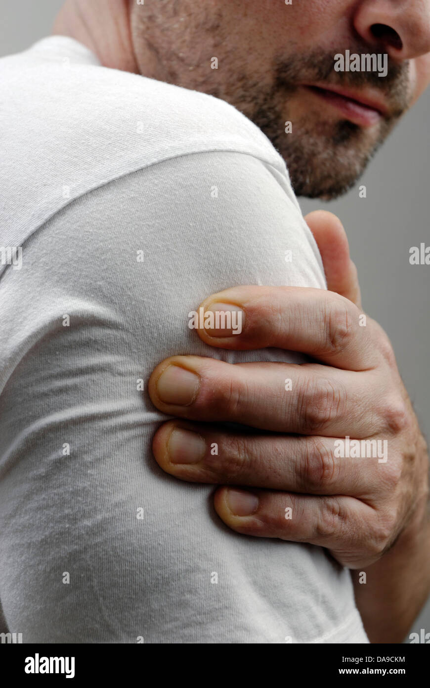 Pain in the upper arm Stock Photo - Alamy