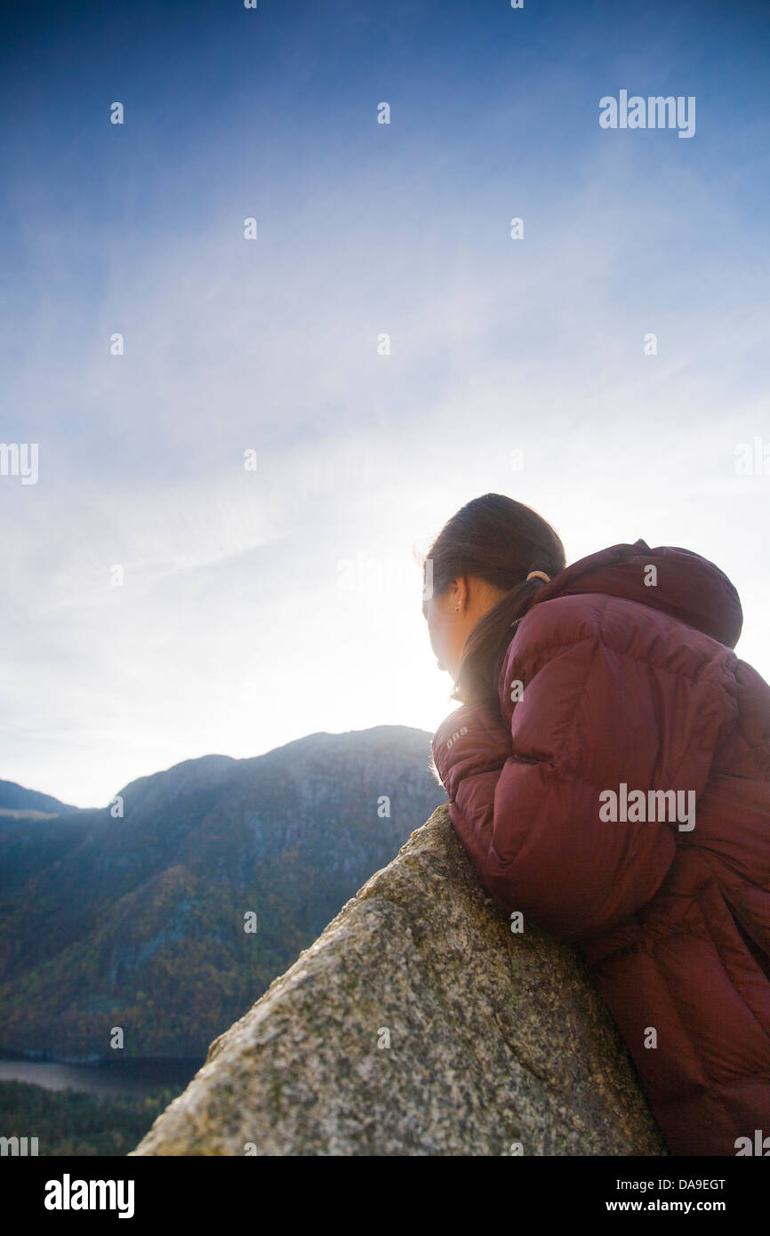 Young woman peering over the edge of a cliff, Norway Stock Photo - Alamy