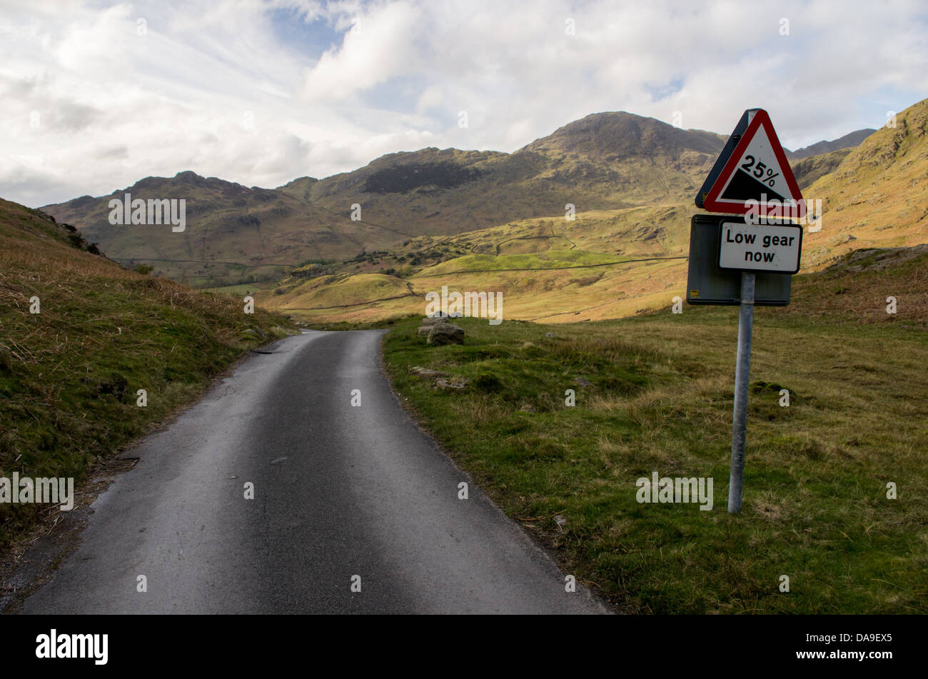 A view of a road going down into a valley with a 25% down Low gear now ...