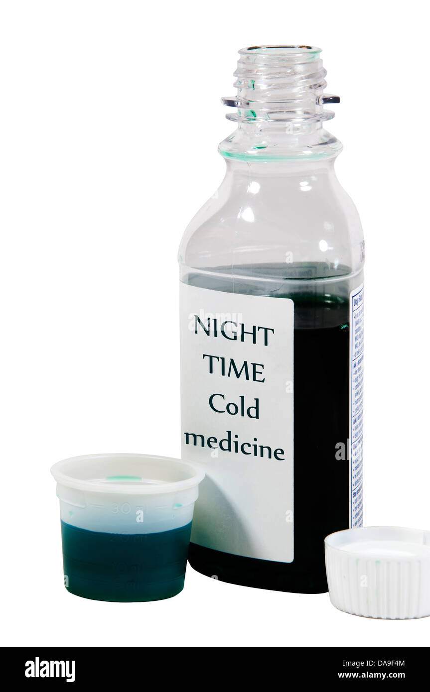 Over the counter night-time cold medicine in a dosage cup. Isolated on ...