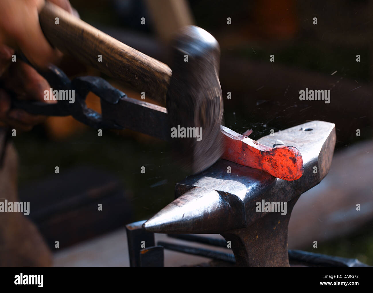 Traditional style blacksmith at work. Hammer hands and iron Stock Photo ...