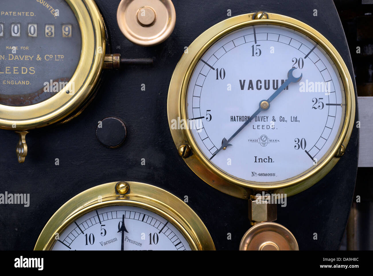 Traditional brass rimmed gauges on a triple expansion steam pumping ...