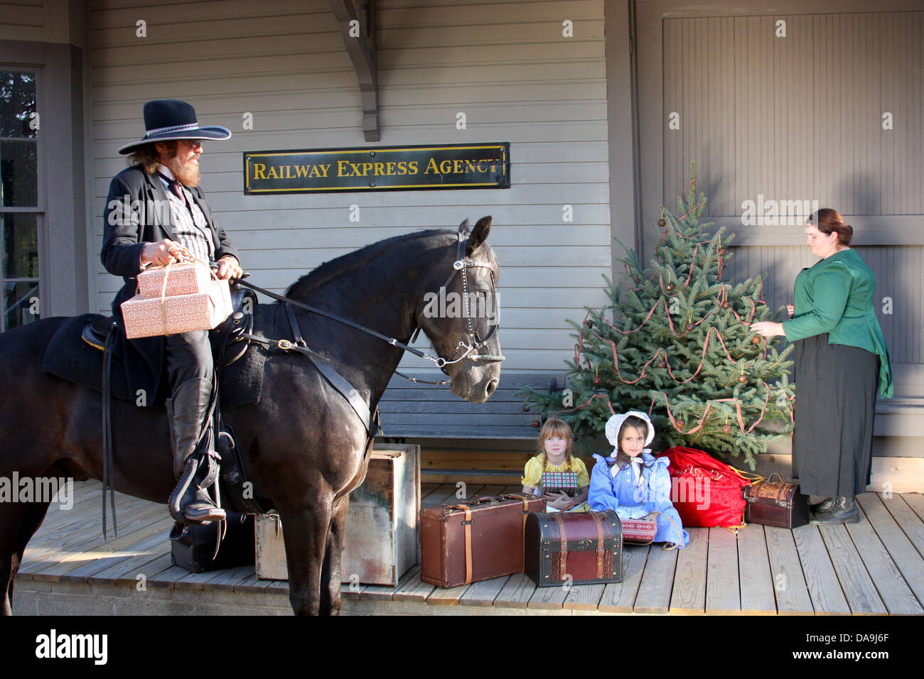 A cowboy delivering Christmas presents to a family Stock Photo - Alamy