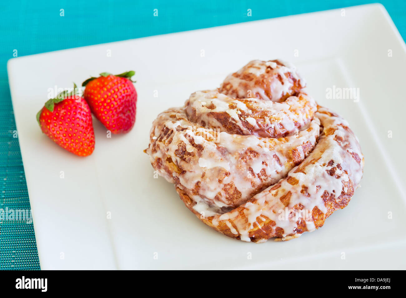 Delicious Cinnamon Roll Sticky Bun with Strawberries Stock Photo - Alamy