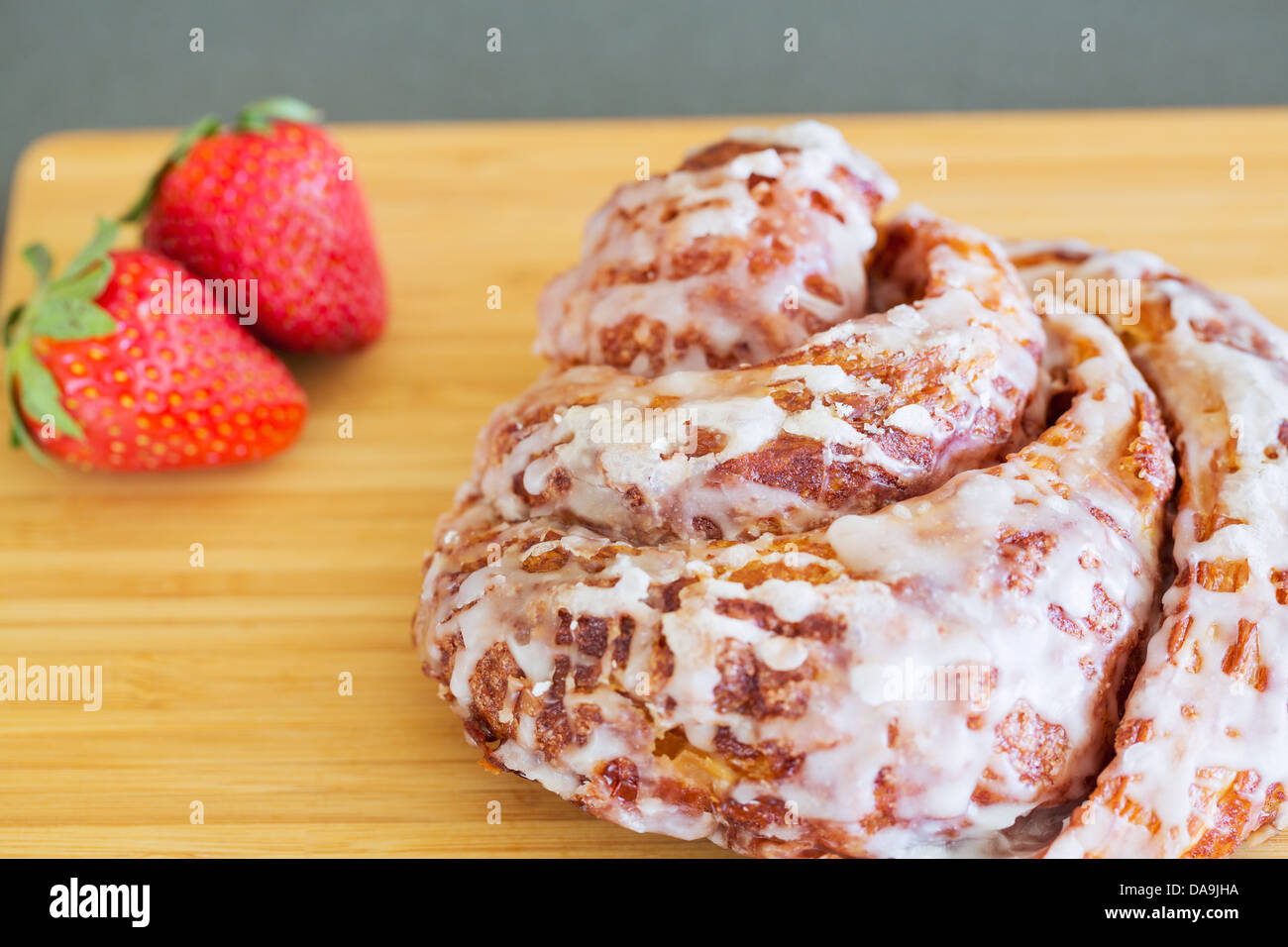 Delicious Cinnamon Roll Sticky Bun with Strawberries Stock Photo - Alamy