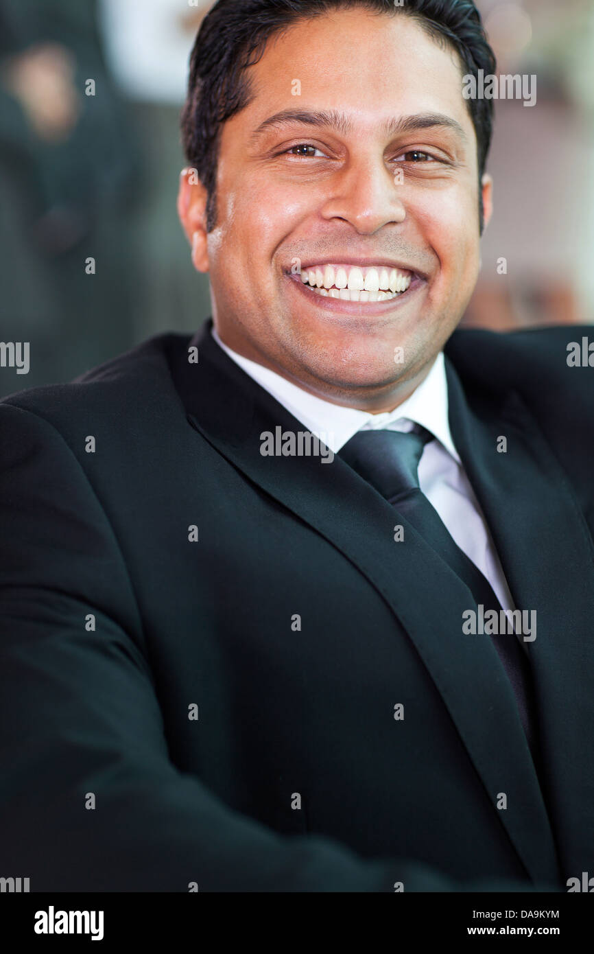 portrait of happy Indian businessman in black suit Stock Photo - Alamy