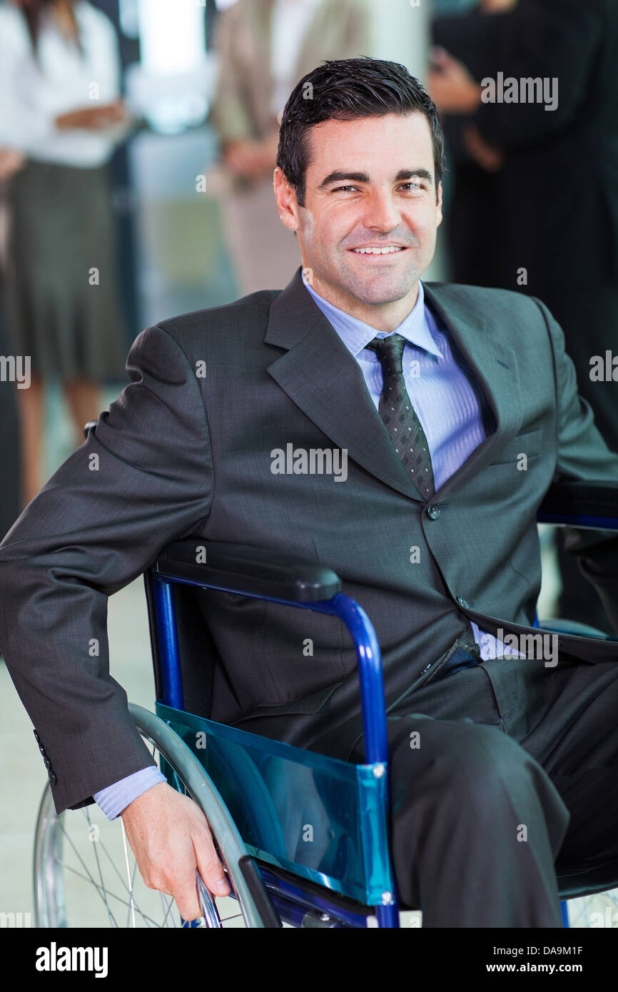 optimistic handicapped business executive sitting in wheelchair in ...