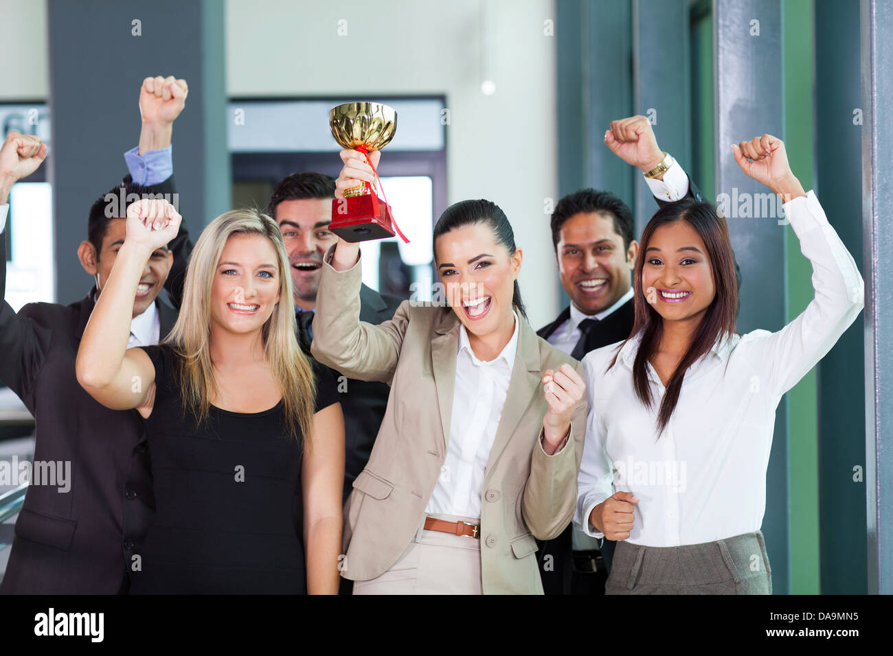 cheerful business team winning an award for their performance Stock ...