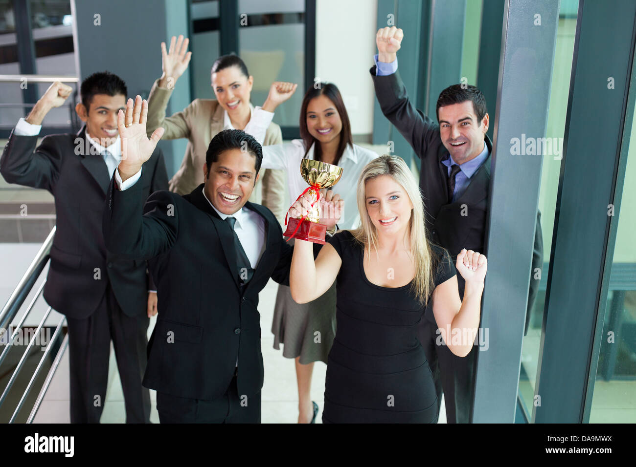excited young business people winning a trophy Stock Photo - Alamy