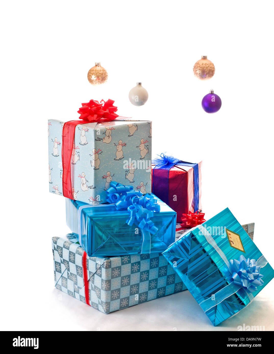 Stack of presents under floating Christmas ornaments Stock Photo - Alamy