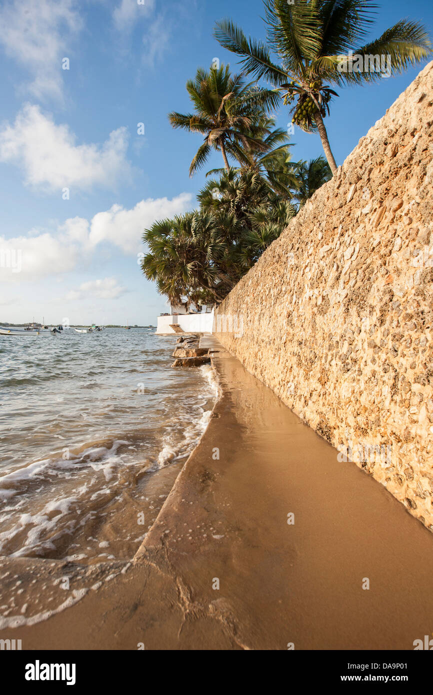 tropical sea wall on a small island Stock Photo - Alamy