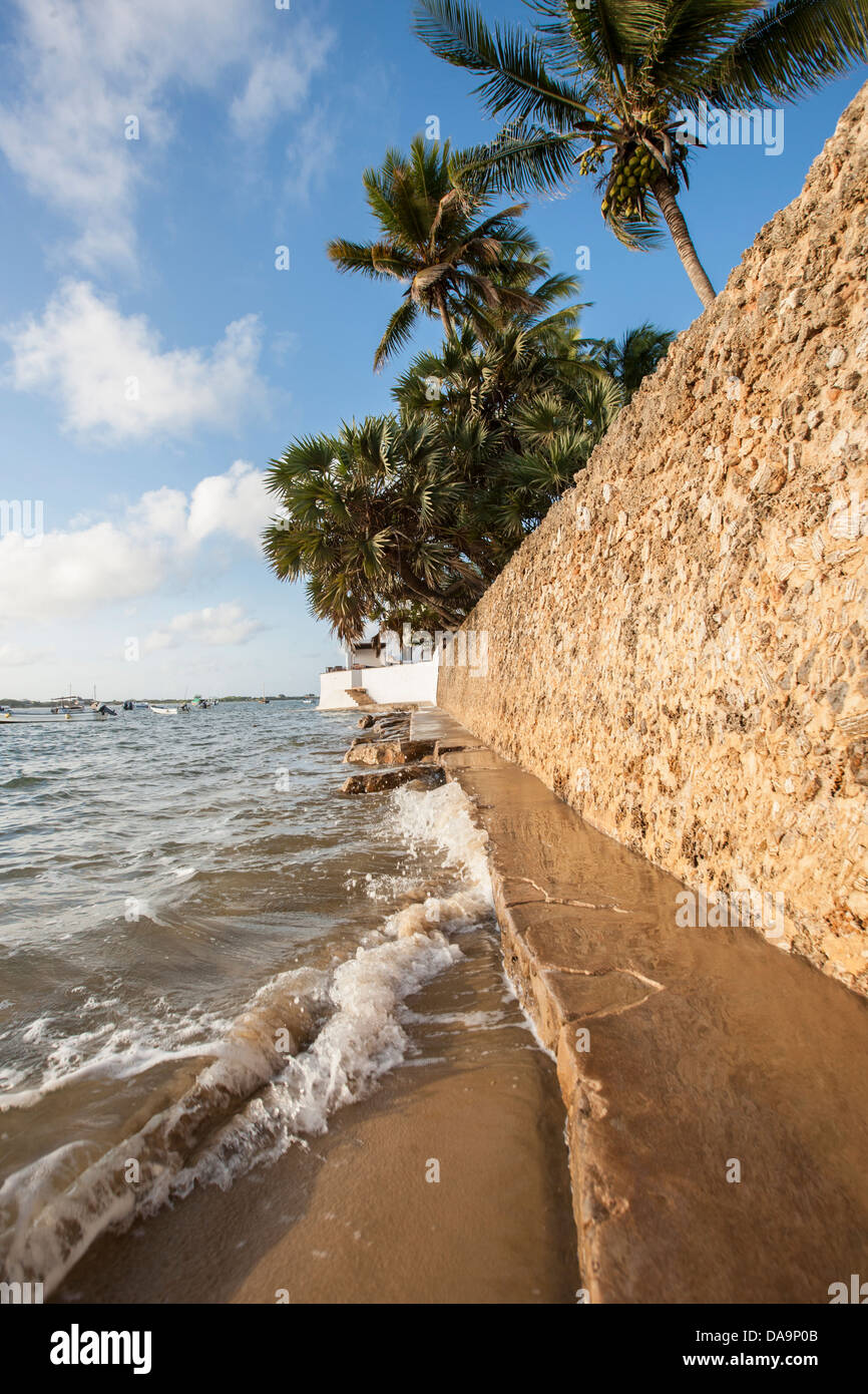 tropical sea wall on a small island Stock Photo - Alamy