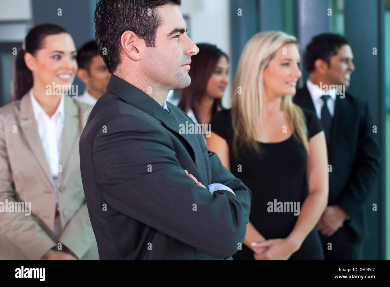thoughtful businessman and colleagues looking outside window Stock ...