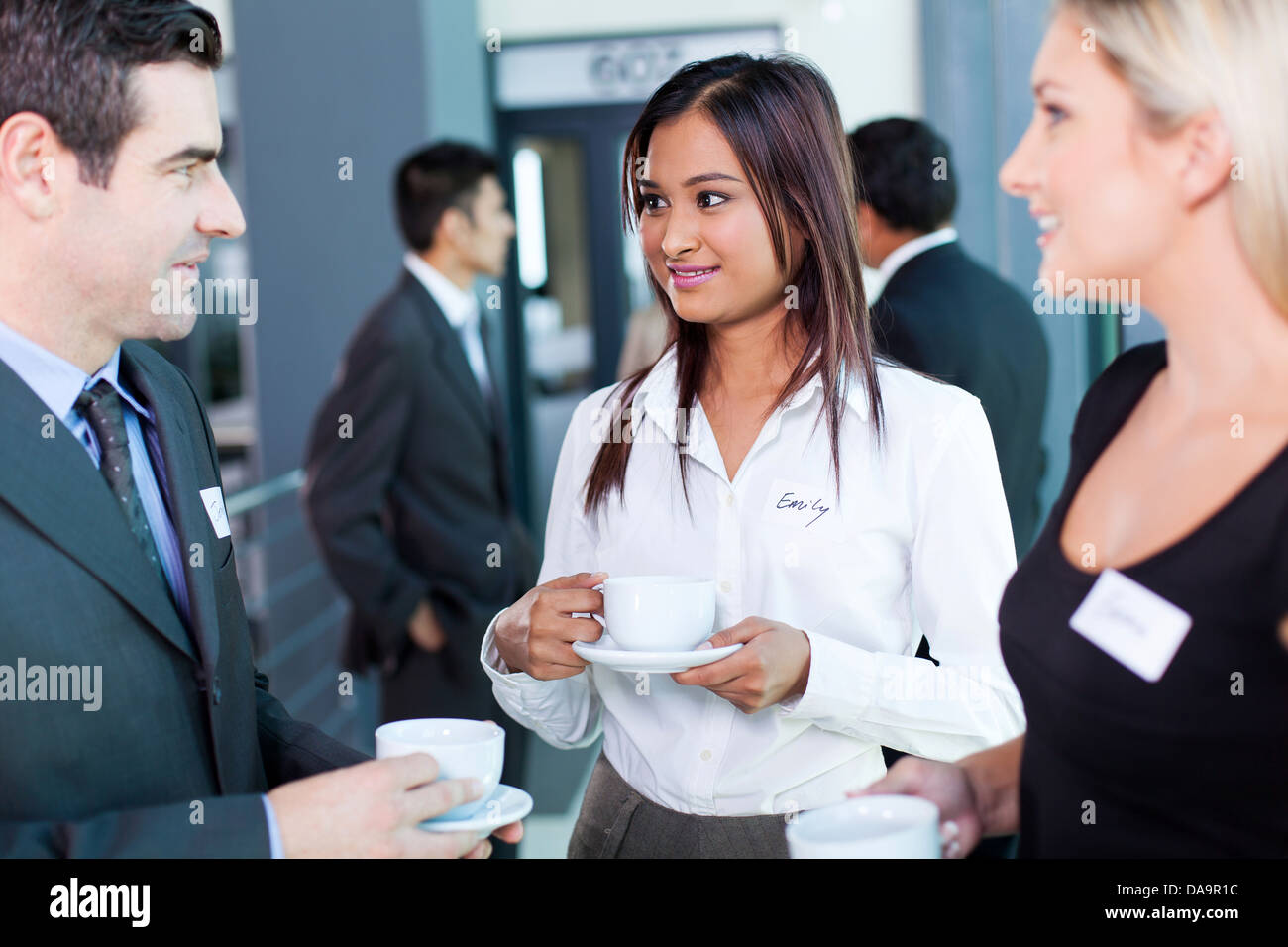 businesspeople interacting during coffee break at business conference ...