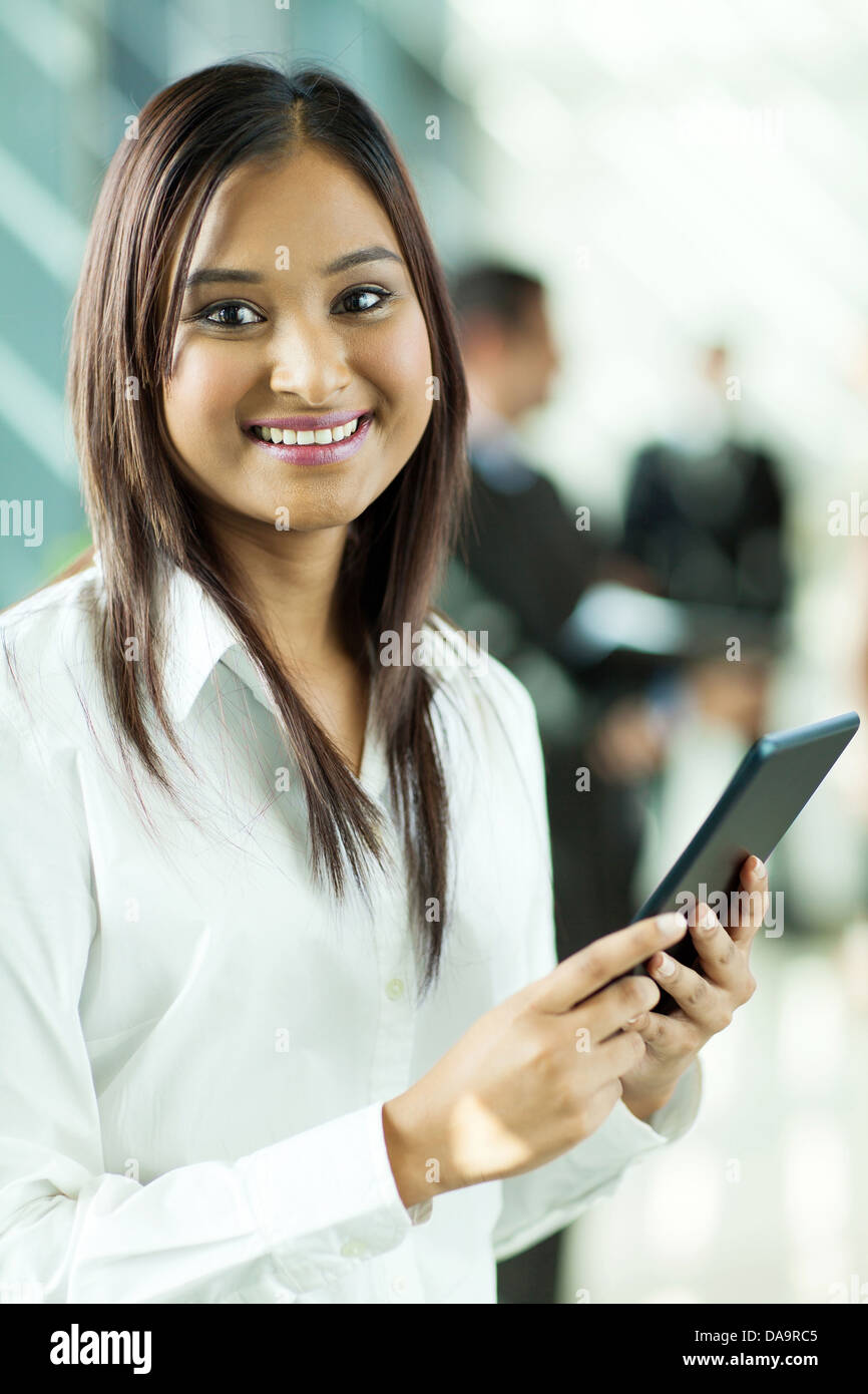 attractive Indian office worker holding tablet computer in office Stock ...