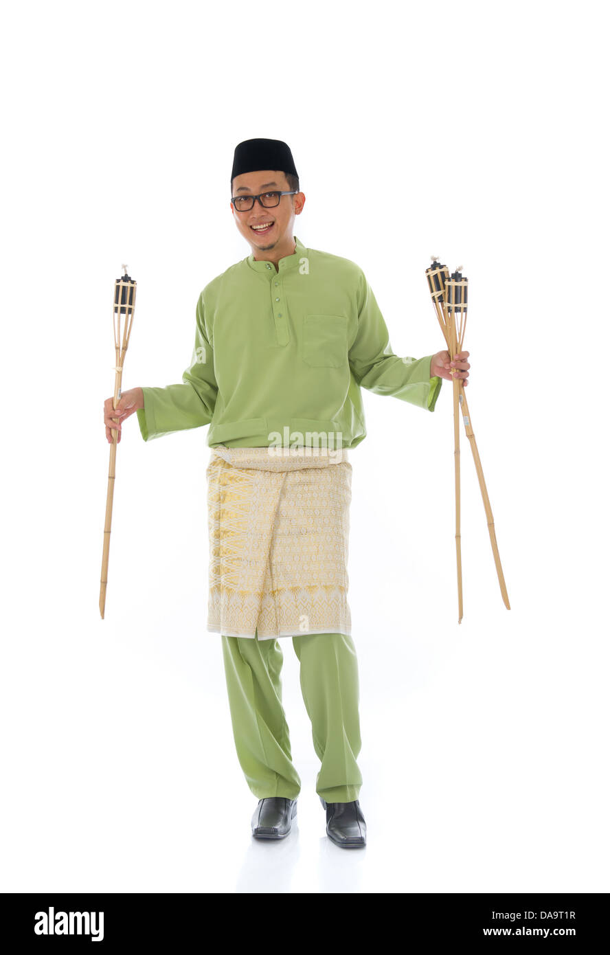 Malay male celebrating hari raya with oil lamp and isolated white ...