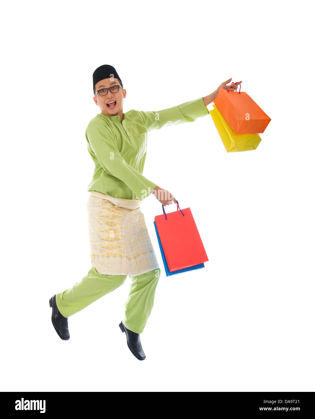 Traditional Malay male shopping and jumping in joy during hari raya ...