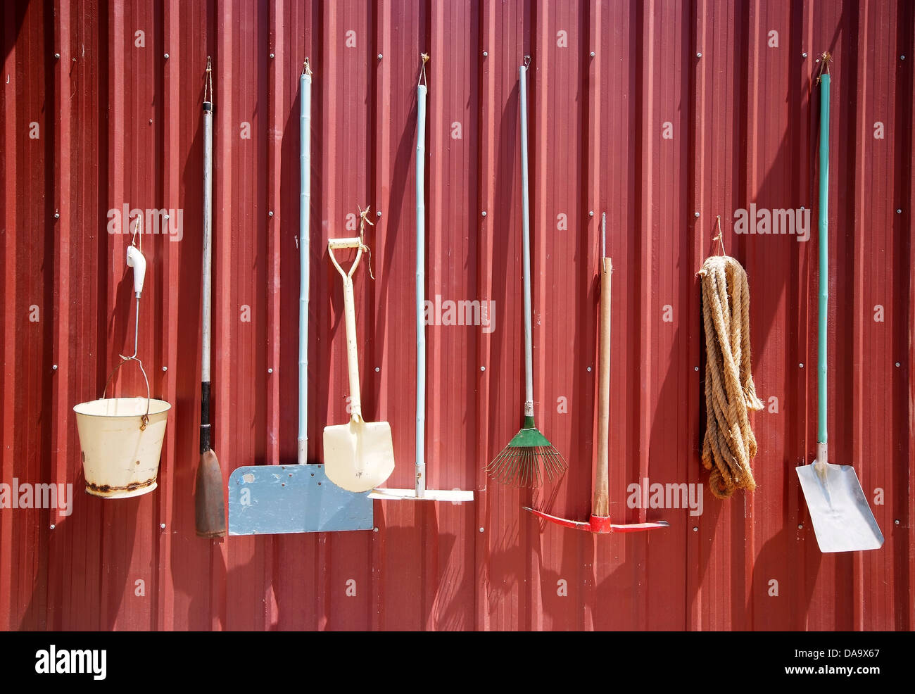 the hardware equipment for farm on the red wall Stock Photo - Alamy