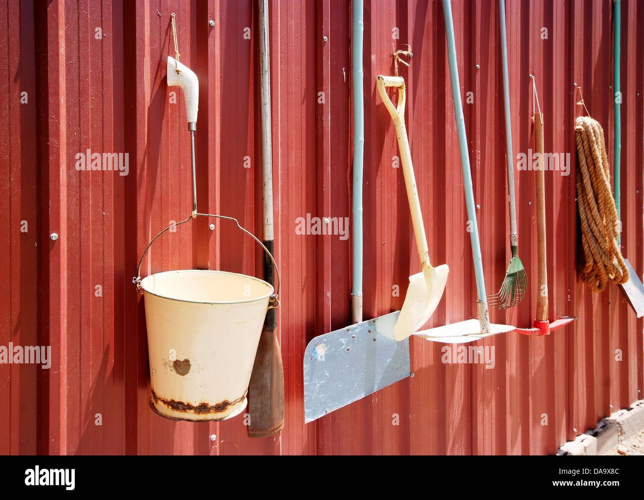 the hardware equipment for farm on the red wall Stock Photo - Alamy