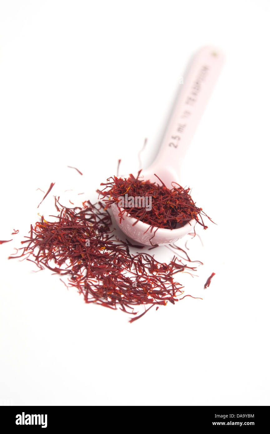 Saffron threads in a pink measuring spoon, commonly used by people ...