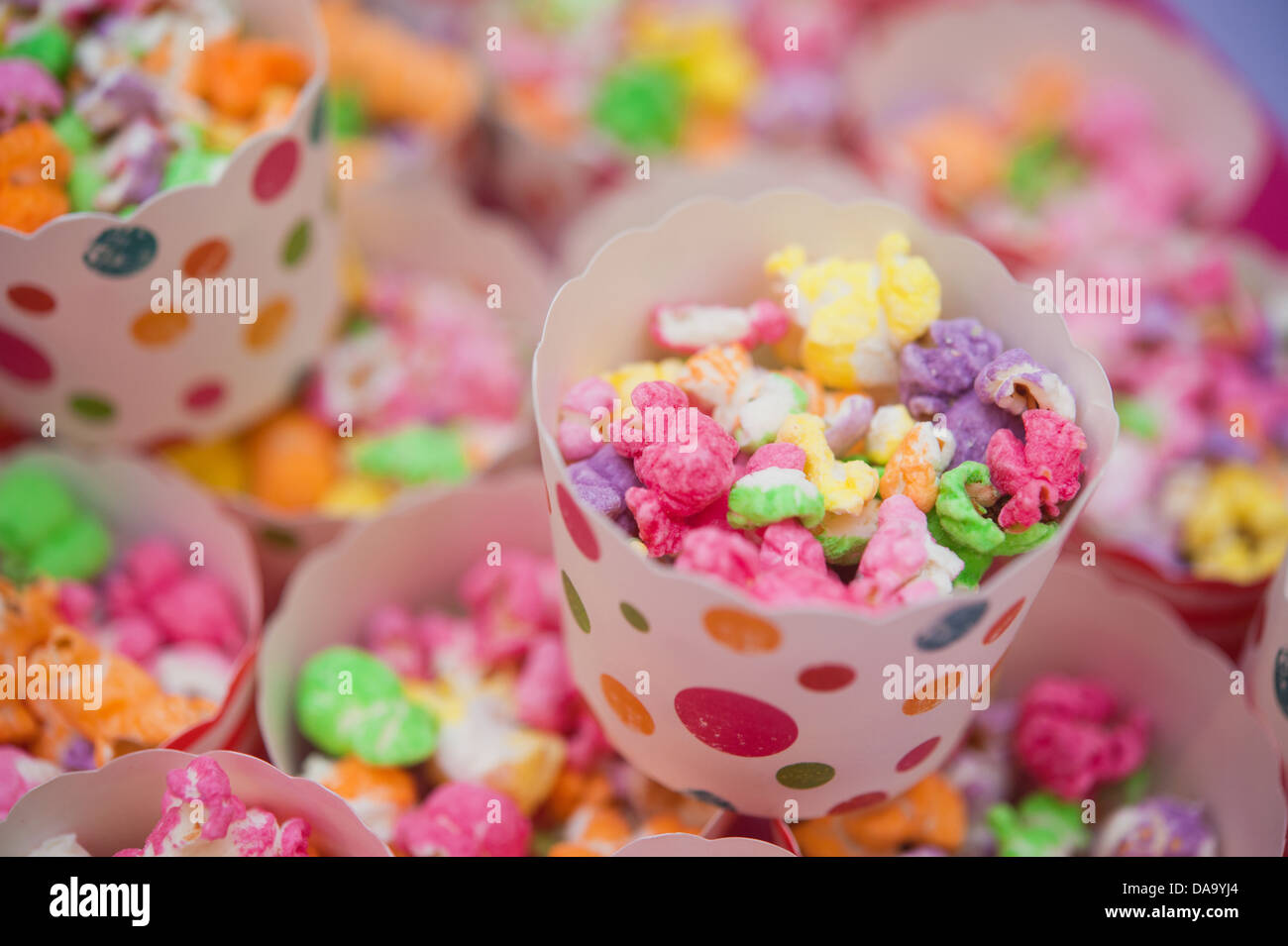Small Cups of coloured popcorn at a party Stock Photo - Alamy