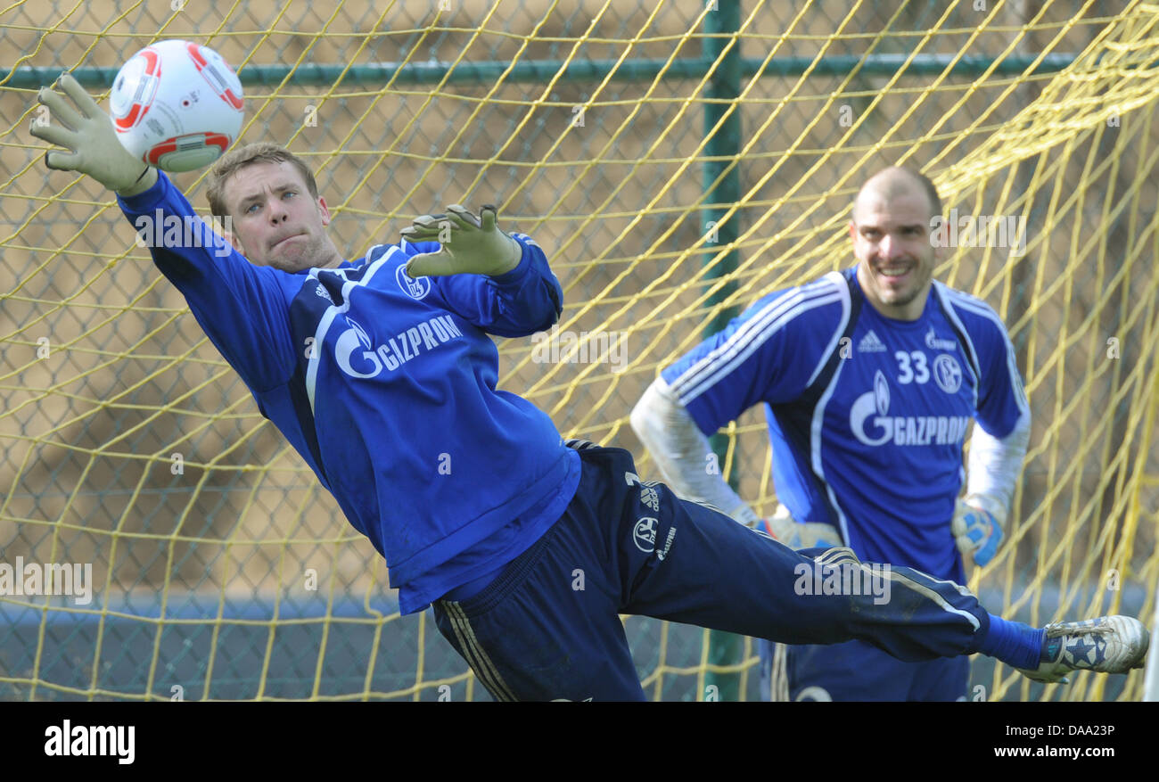 Schalke's goalkeeper Manuel Neuer (L) stops a ball, while reserve ...
