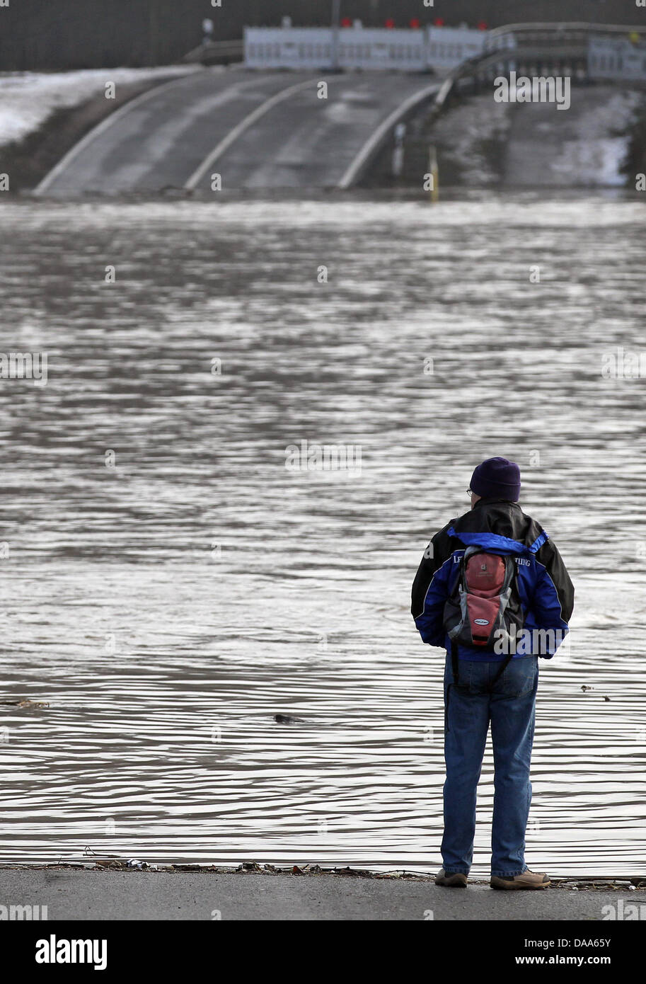 A man watches the high waters of Weisse Elster river in Leipzig ...