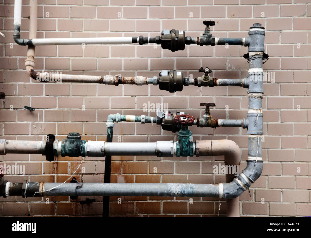 It's a photo of some pipes along the wall. It's the plumbing of the ...