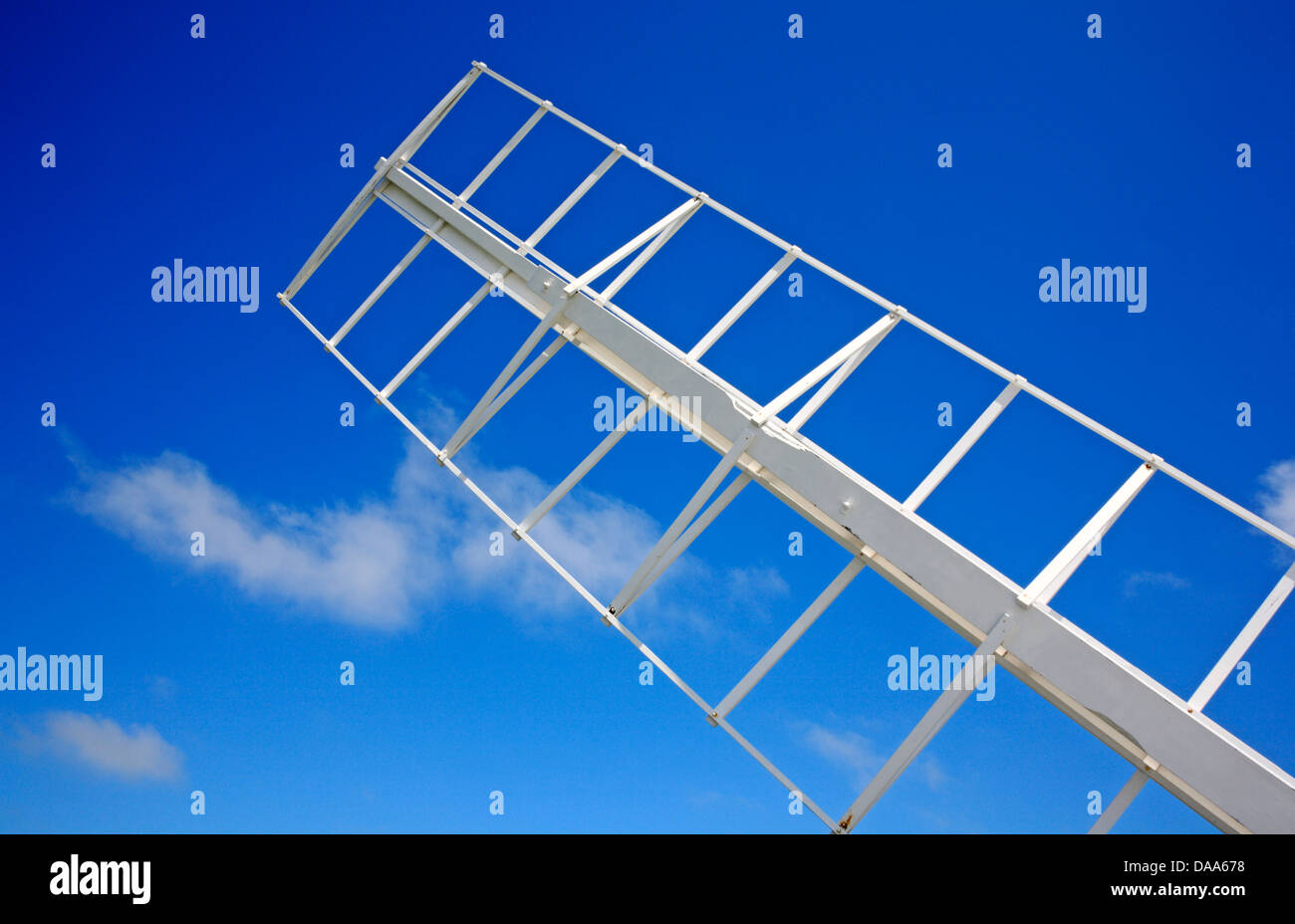 A single windmill sail pointing diagonally against a blue sky Stock ...