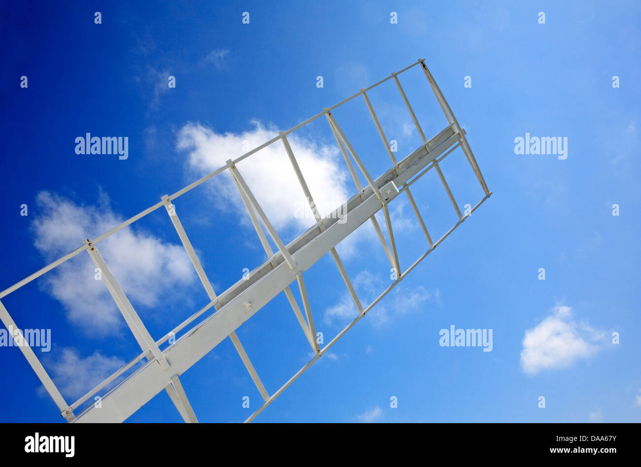 A single windmill sail pointing diagonally against a blue sky Stock ...