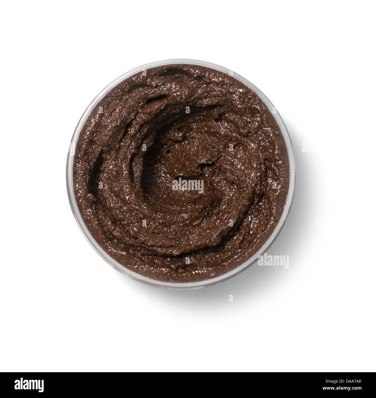 pot of dark brown body scrub paste cut out onto a white background ...