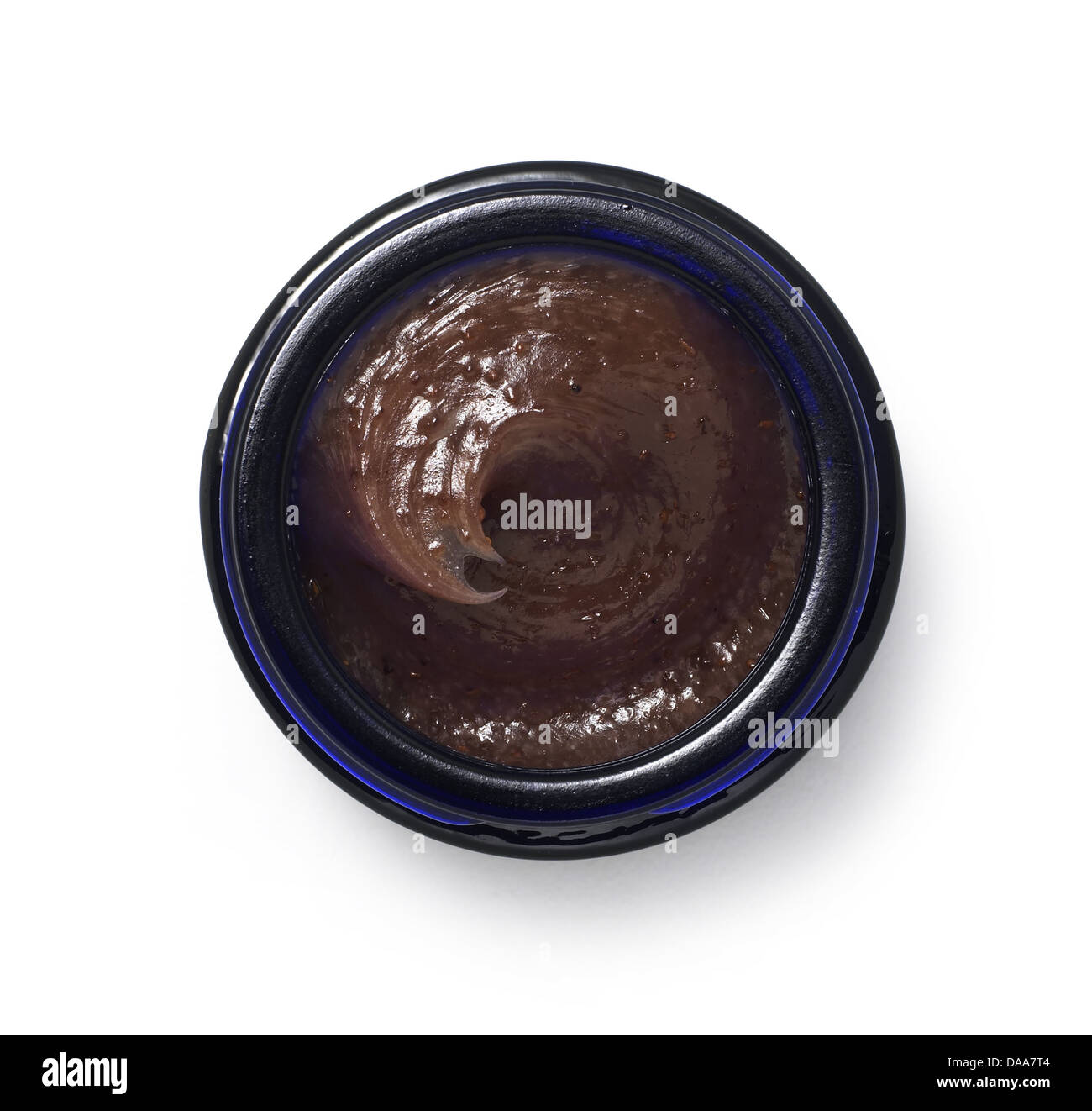 pot of dark brown body scrub paste cut out onto a white background ...