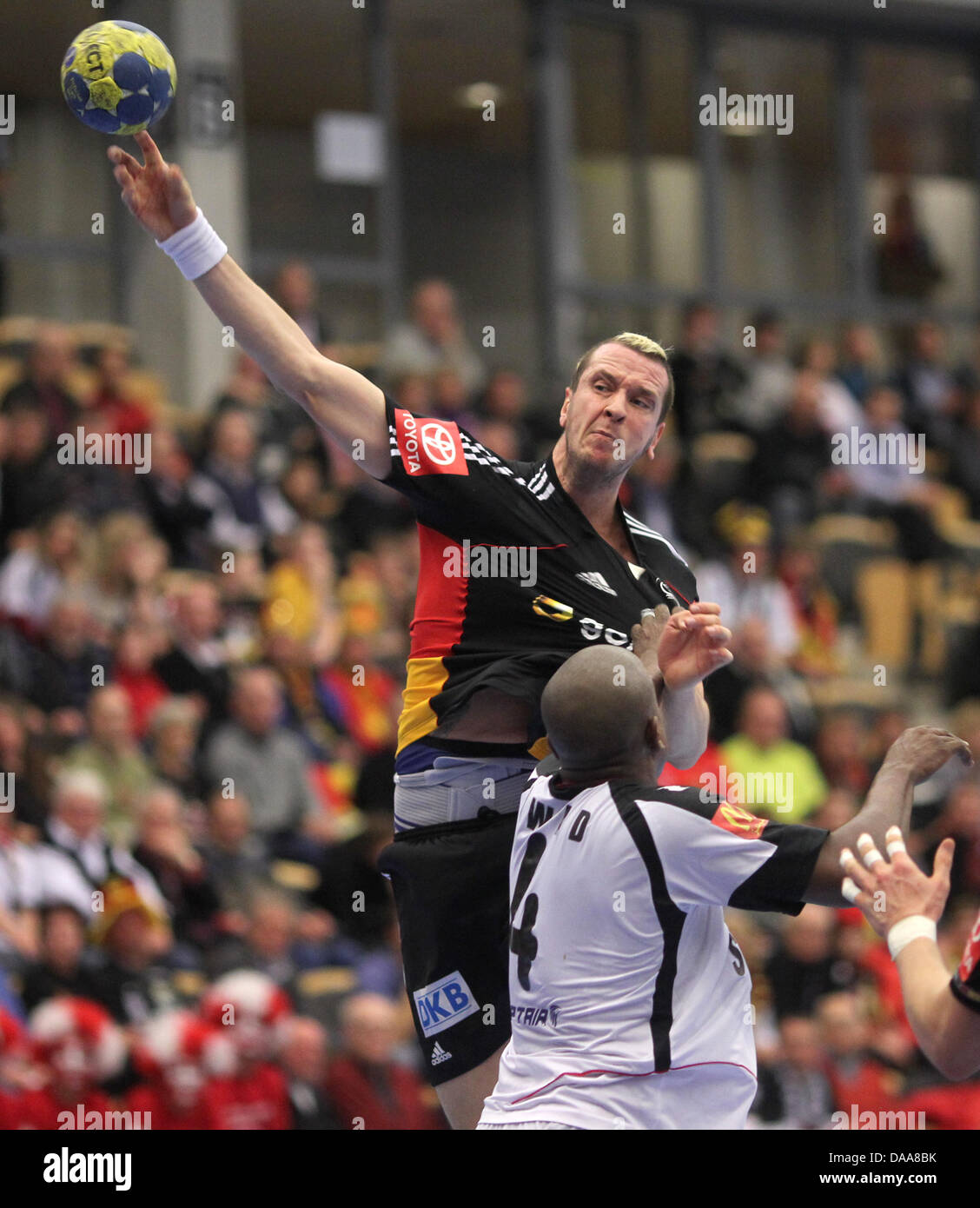 Pascal Hens (up) of Germany in action against Belal Mabrouk (R) of ...