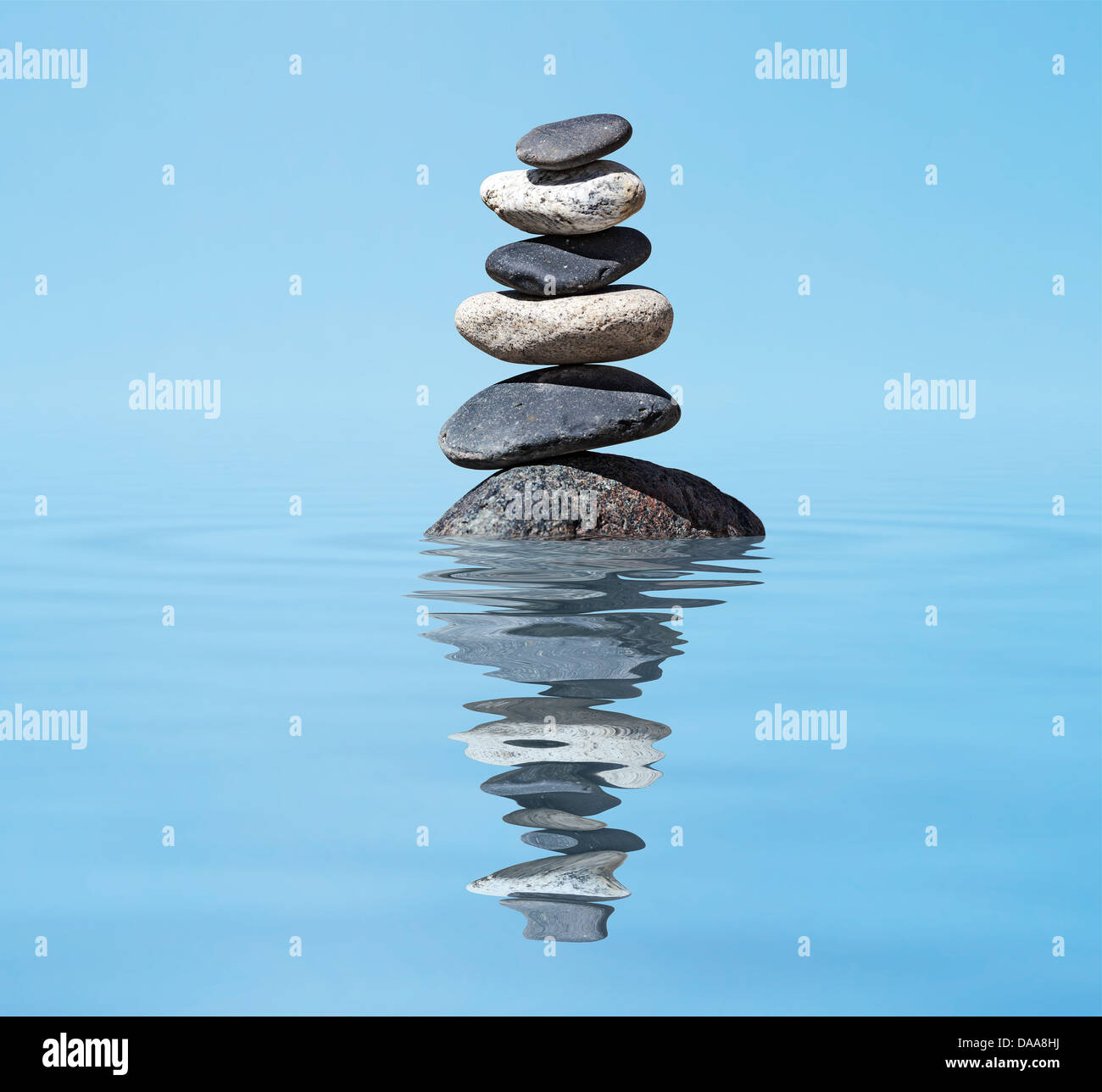 Zen meditation background - balanced stones stack in water with ...