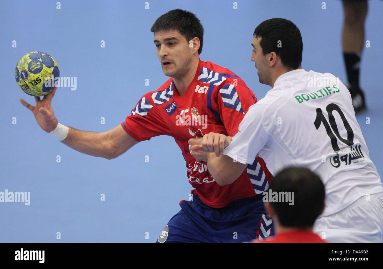 Serbia's Nenad Vuckovic (L) and Algeria's Saci Boultif fight for the ...