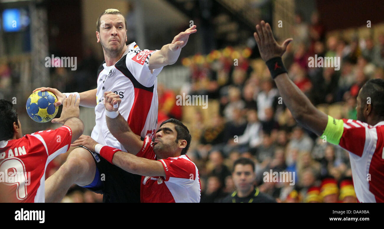 Pascal Hens (Center) of Germany in action against Mohamed Merza (L) and ...