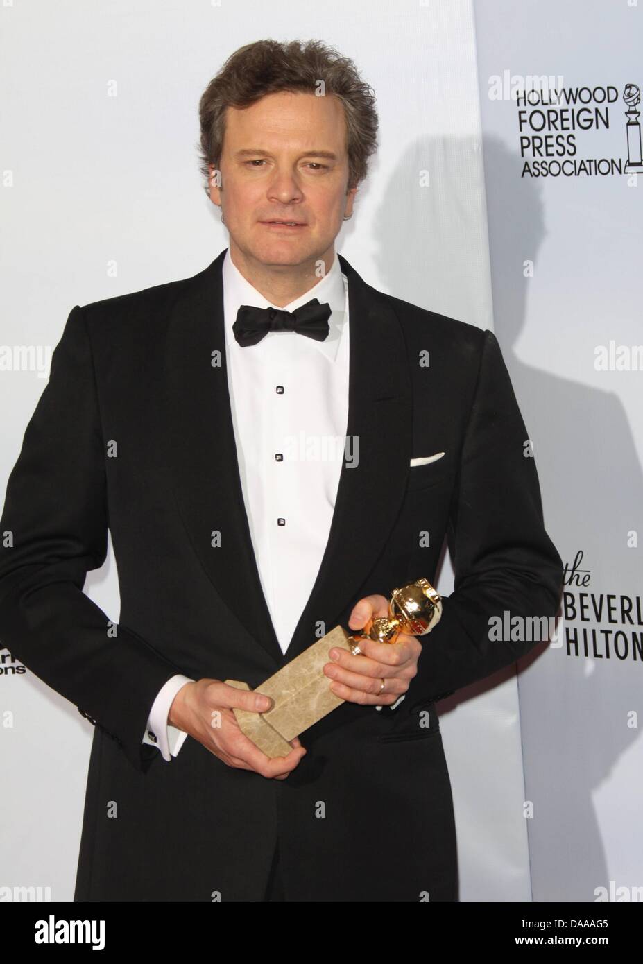 British actor Colin Firth holds up his award for 'Best Performance by ...