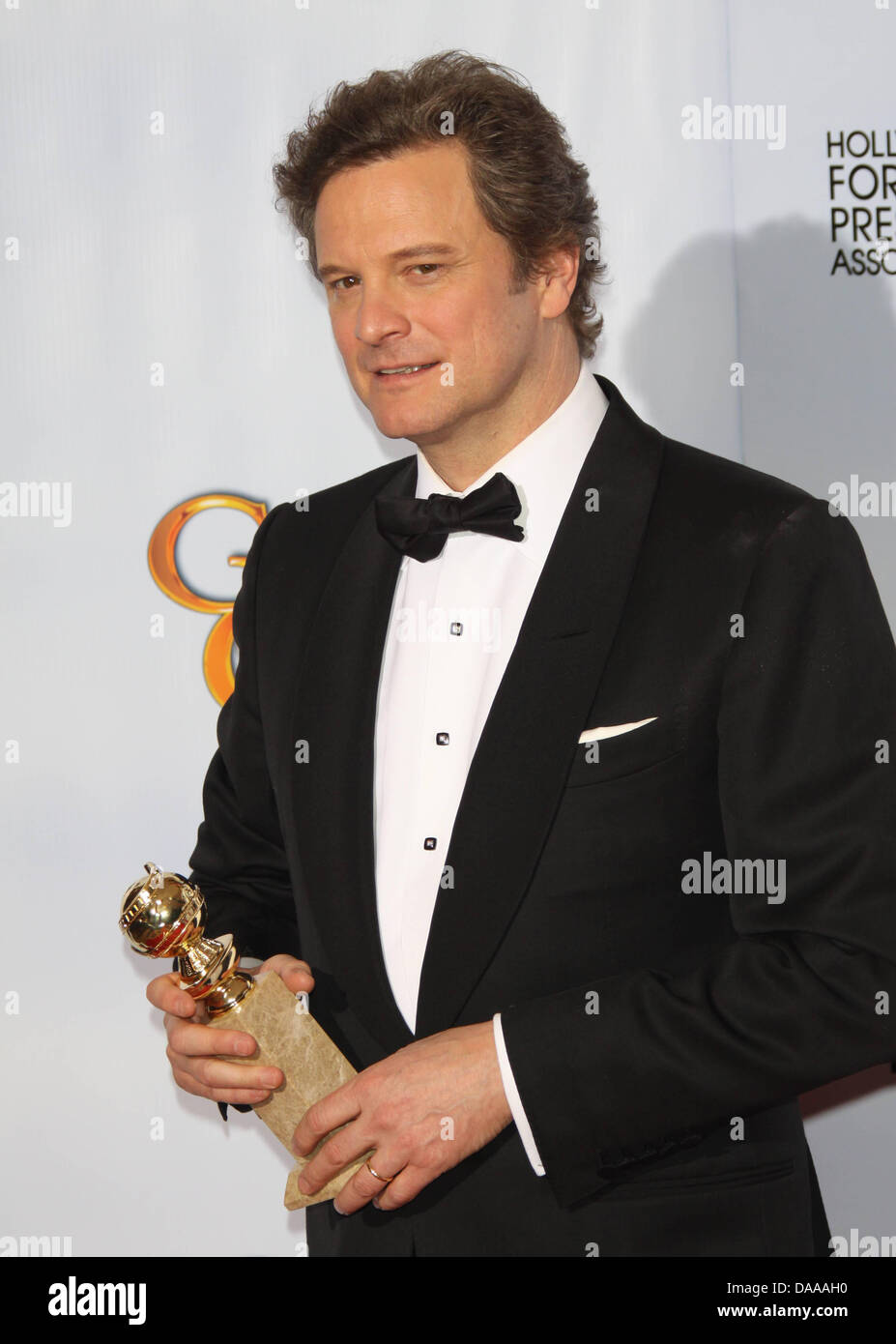 British actor Colin Firth holds up his award for 'Best Performance by ...