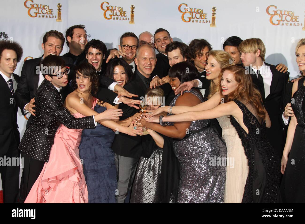 Cast members of 'Glee' pose with the award for Best Television Series ...