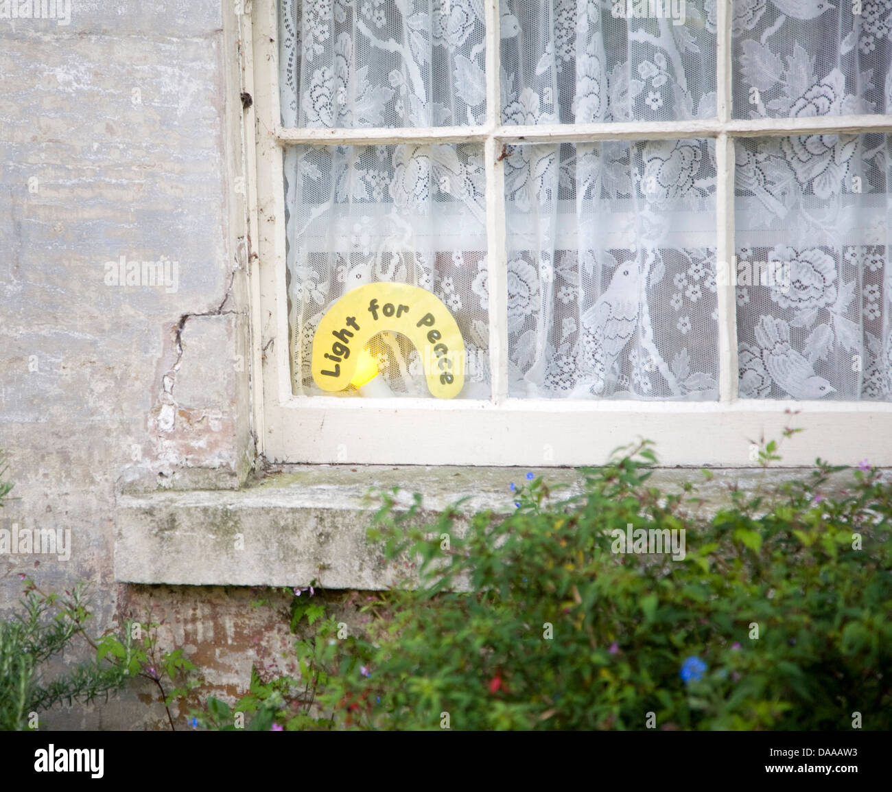 Sign Light for peace shining in window of house Stock Photo - Alamy