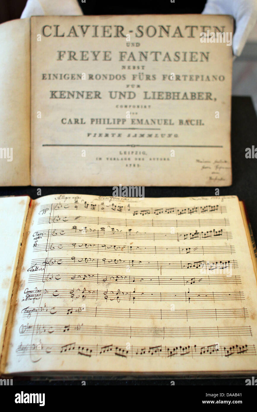 An employee with gloves opens an original score of the Bach opera ...