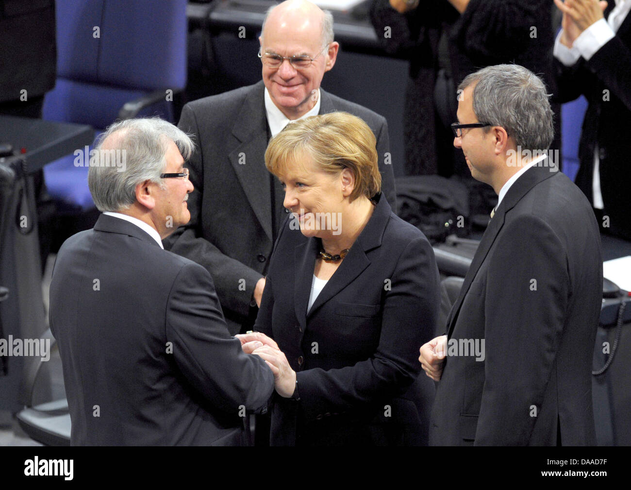 German Chancellor Angela Merkel (C) shakes hands with Dutch-born Roma ...