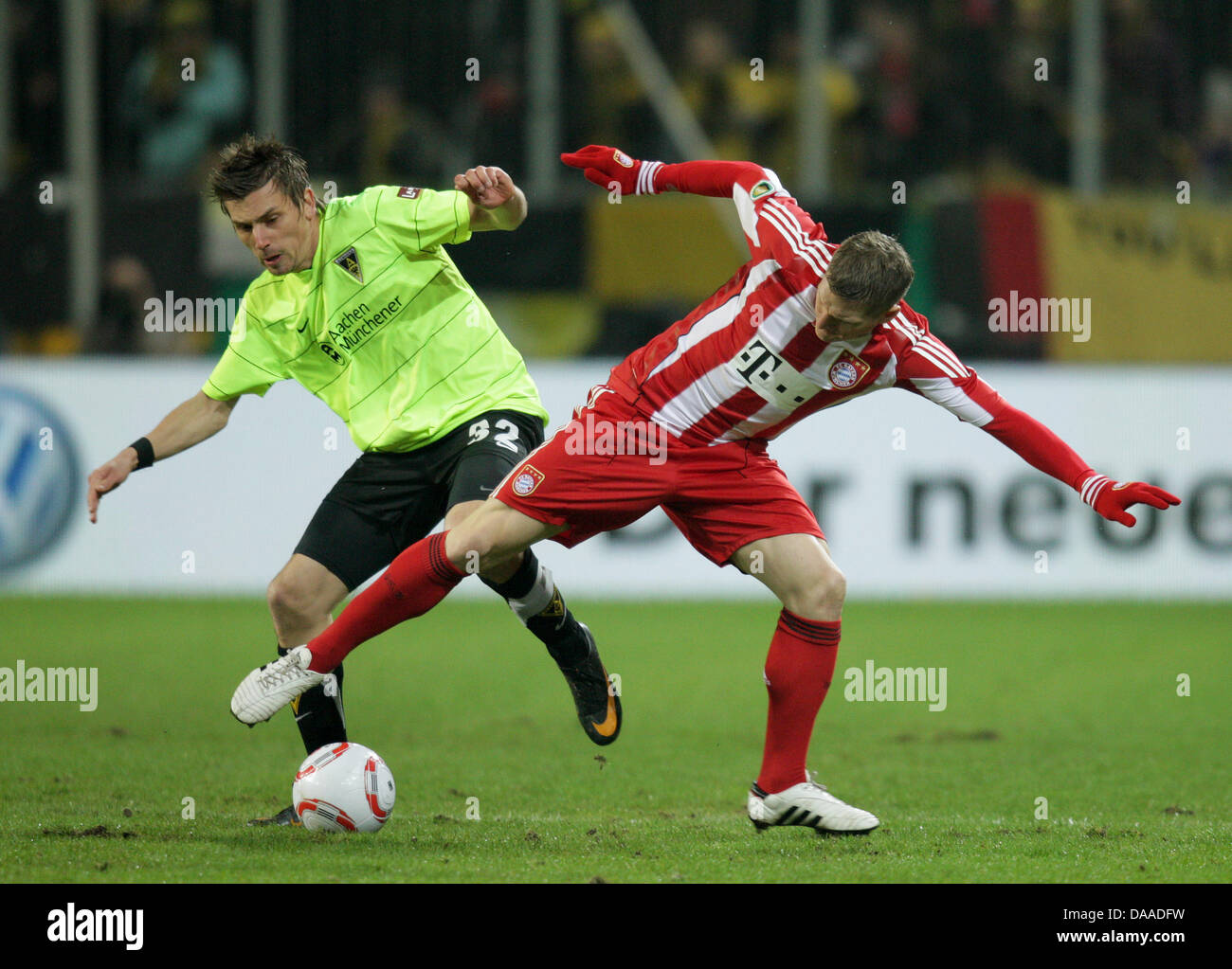 Aachen's Timo Achenbach (L) and Munich's Bastian Schweinsteiger (R) vie ...