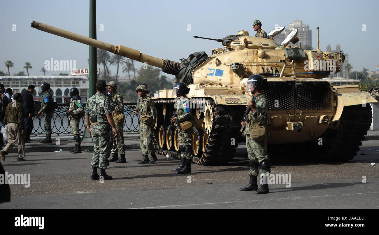 Soldiers with a tank block a street in the inner city of Cairo, Egypt ...