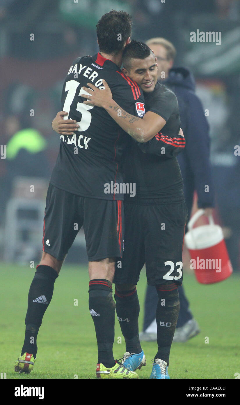 Leverkusen's Michael Ballack (L) and Arturo Vidal emrbace each other ...