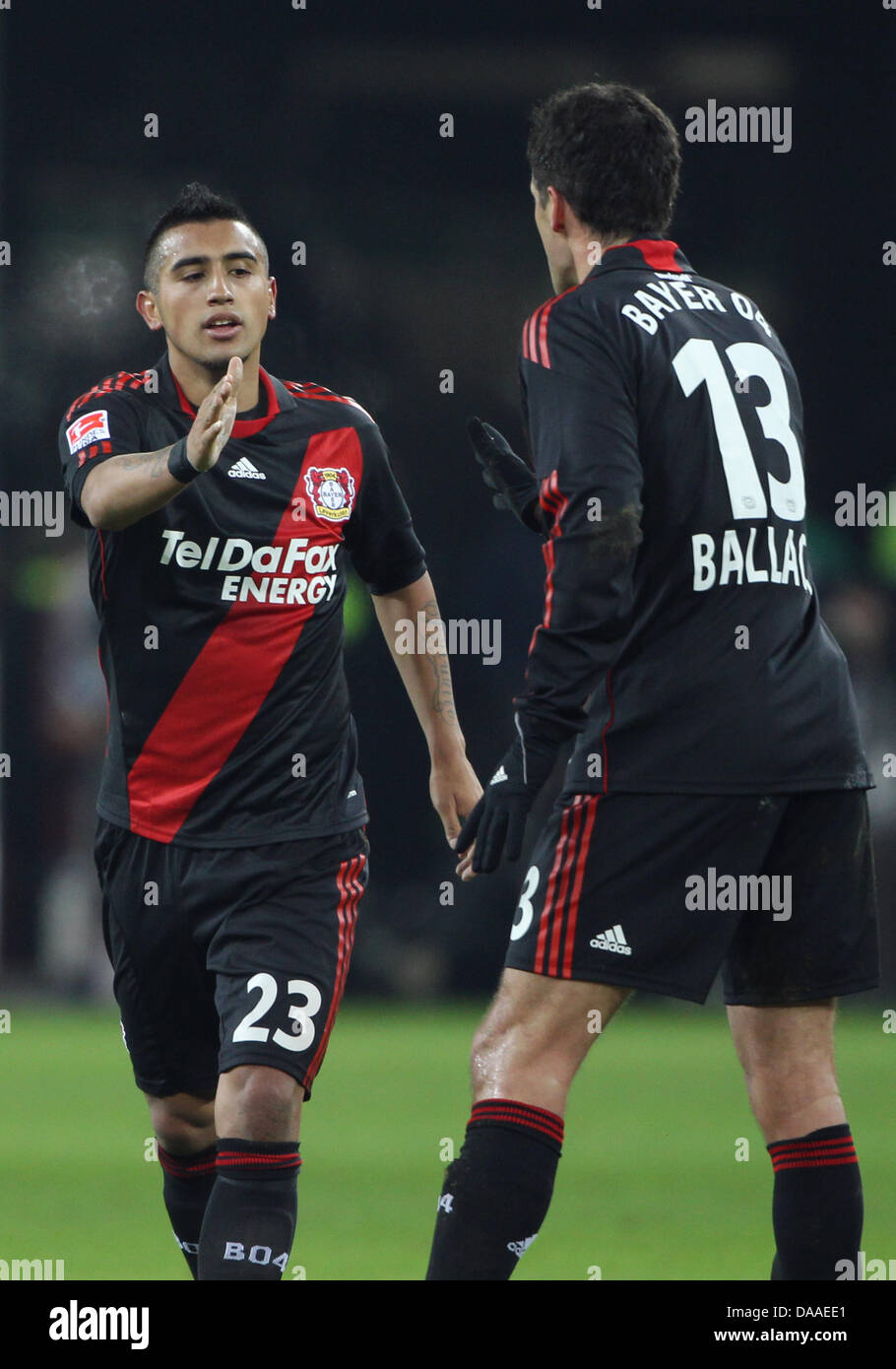 Leverkusen's Arturo Vidal (L) gives his teammate Michael Ballack a five ...