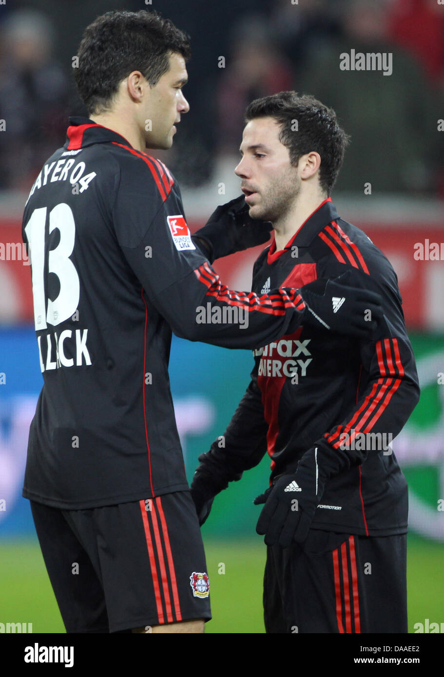 Leverkusen's Michael Ballack (L) taps the shoulder of his teammate ...