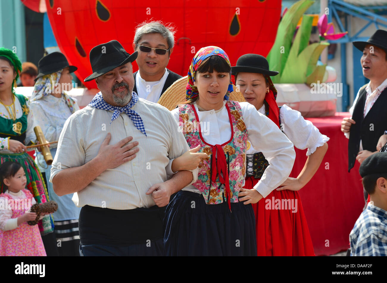 Dancers in traditional Portuguese dress take part in folk dancing at ...